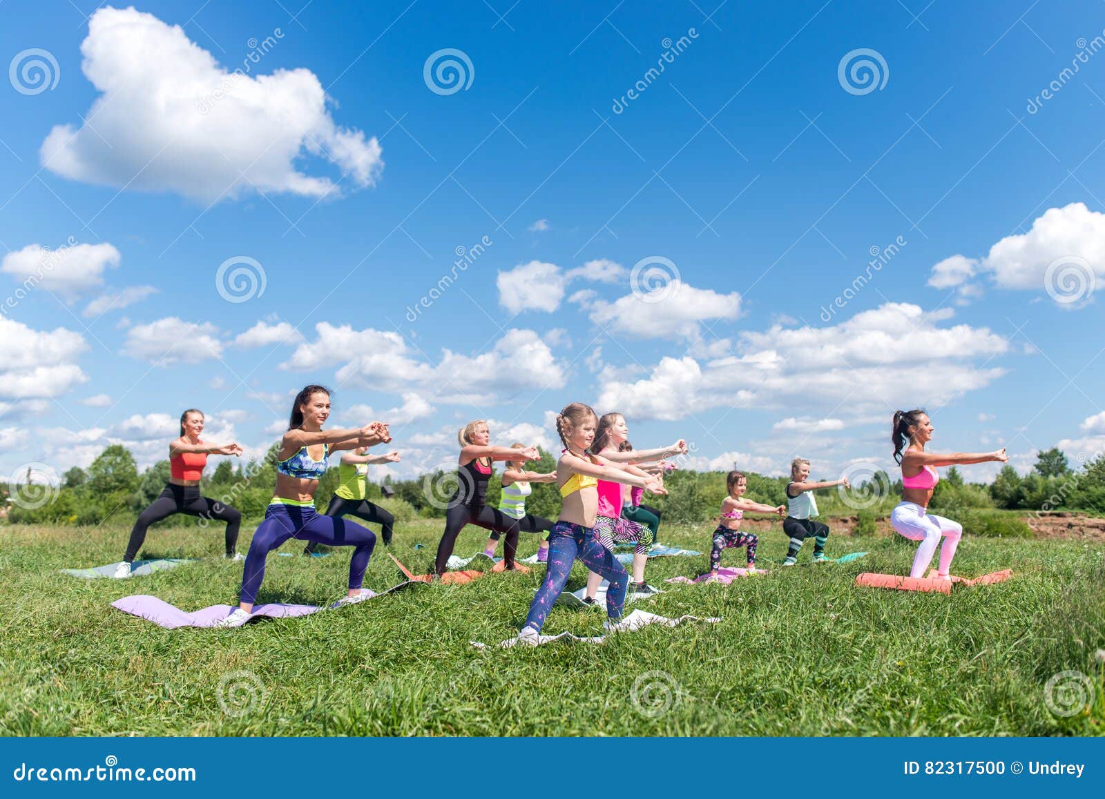Group of Women Exercising and Doing Squats at Boot Camp. Stock Photo ...