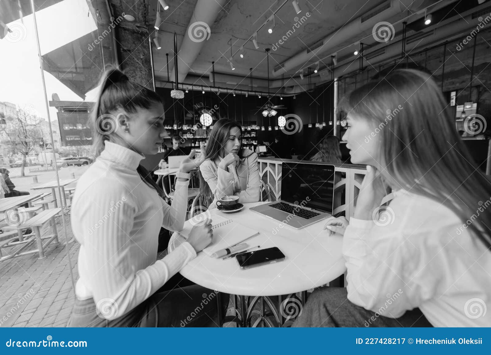 A Group of Women Friends in a Cafe Working on a Project Stock Image ...
