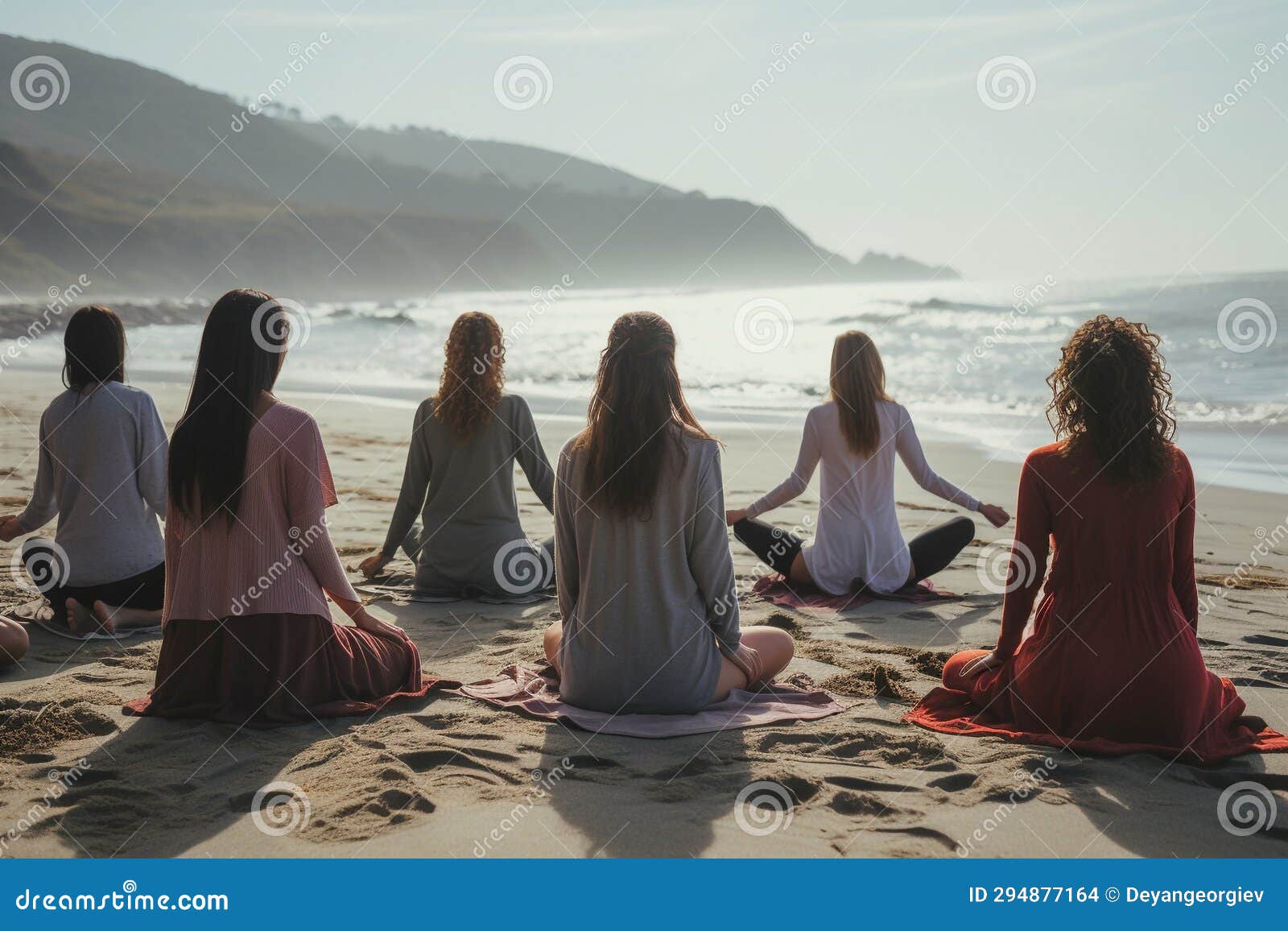 A Group of Women Meditating on a Beach Sit on the Sand Stock ...