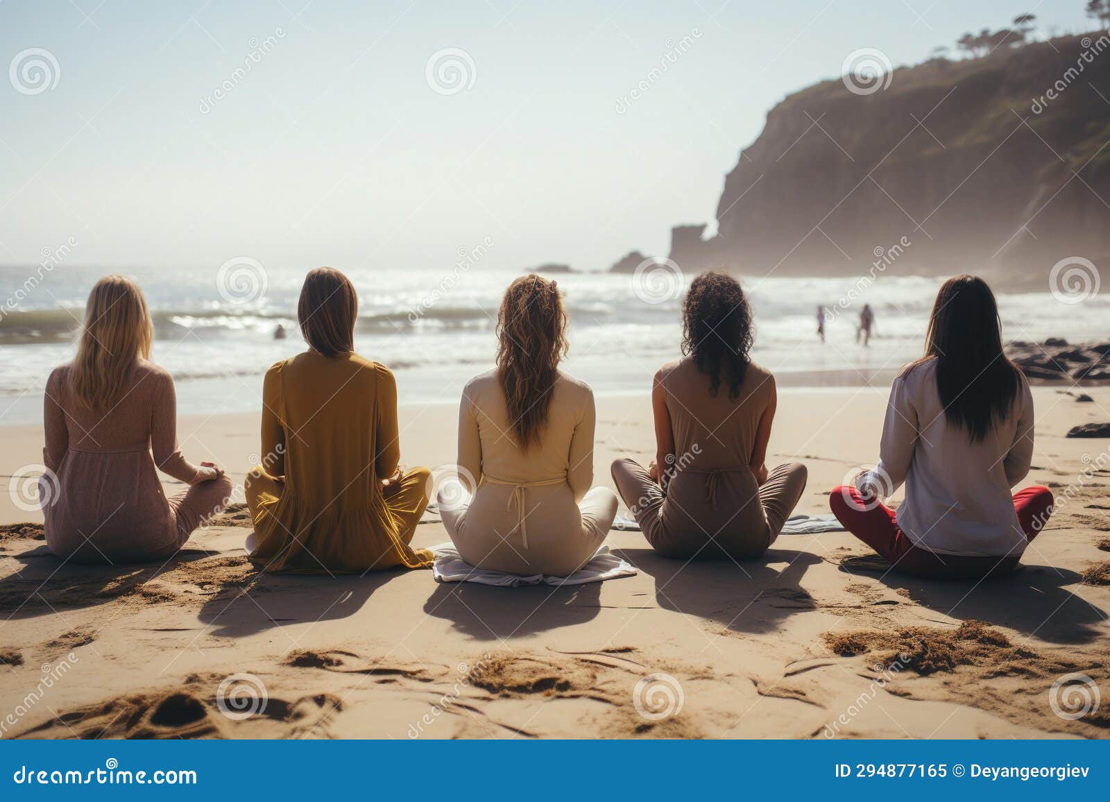 A Group of Women Meditating on a Beach Sit on the Sand Stock ...