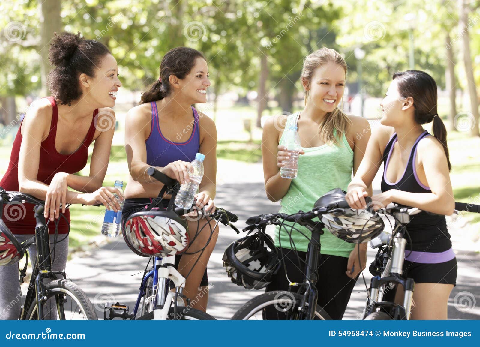 Group of Women Resting during Cycle Ride through Park Stock Photo ...