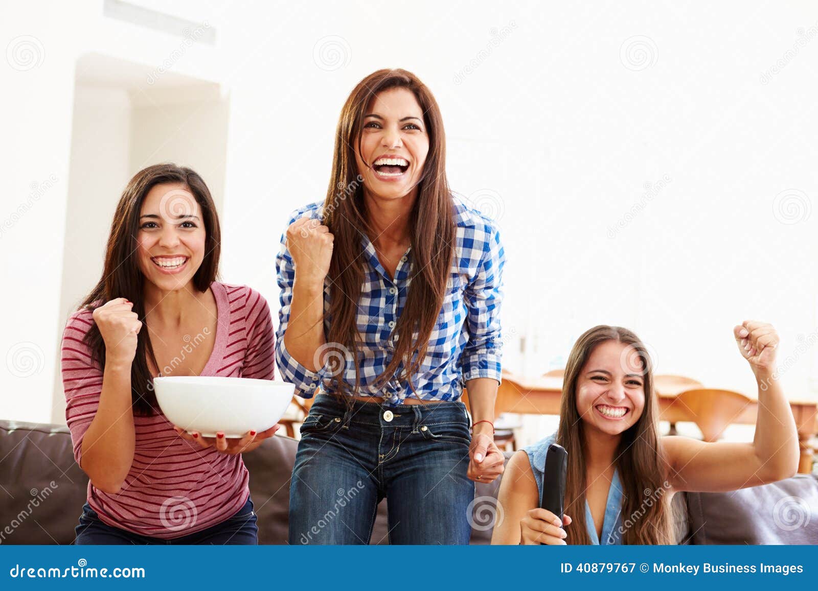 Group Of Women Sitting On Sofa Watching Sport Together Stock Image