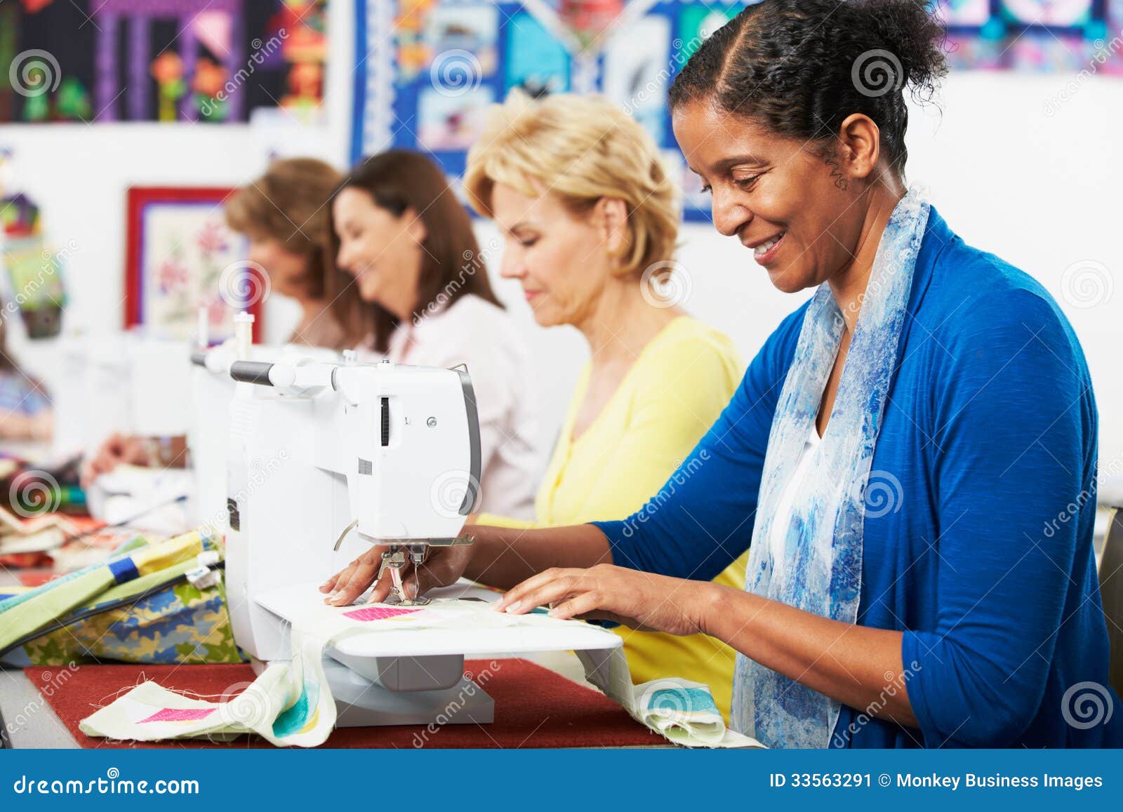 Group of Women Using Electric Sewing Machines in Class Stock Image ...