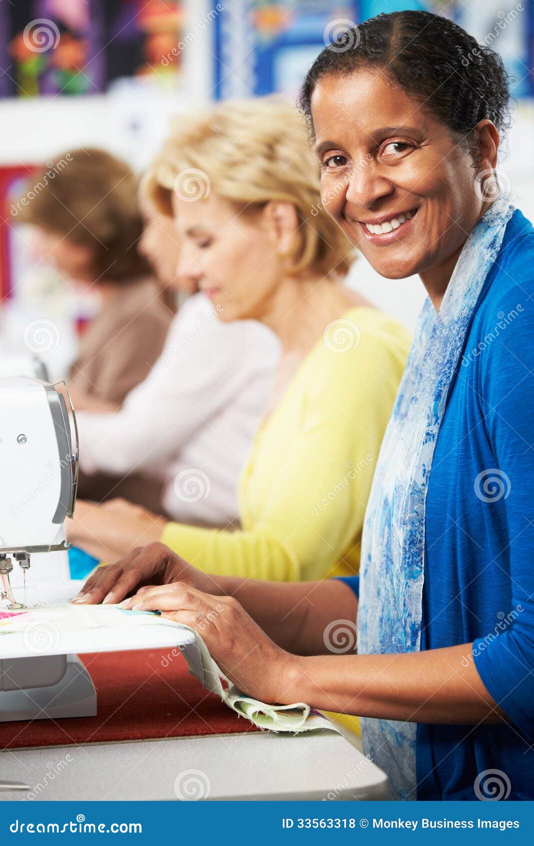 Group of Women Using Electric Sewing Machines in Class Stock Photo ...