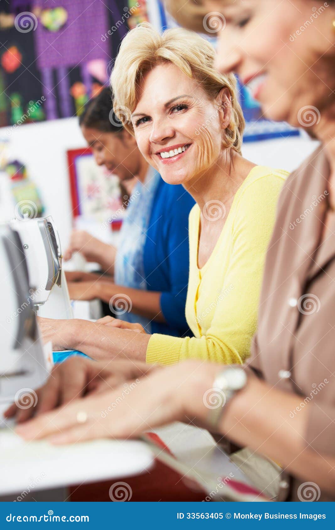 Group of Women Using Electric Sewing Machines in Class Stock Image ...