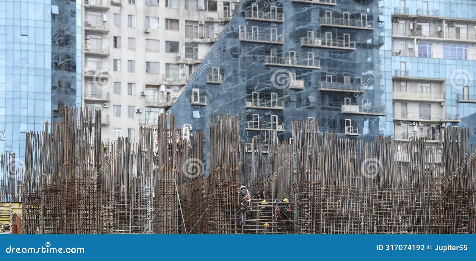 Group of Workers Assembling Framework of Building from Iron Fittings ...