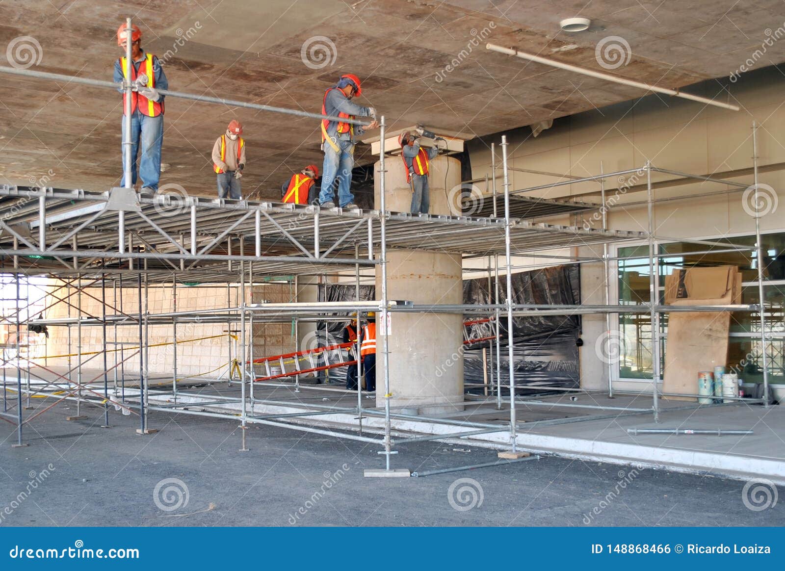 Workers Assembling Scaffolding and Working on the Roof of a Parking Lot ...