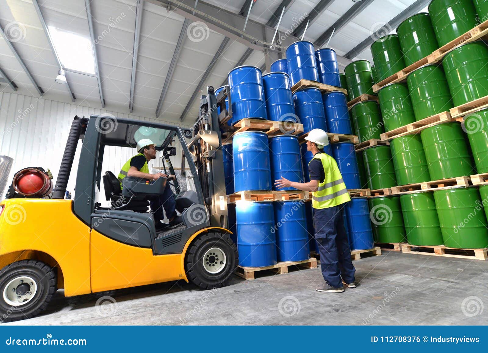 Group of Workers with Forklift in the Logistics Industry Working Stock ...