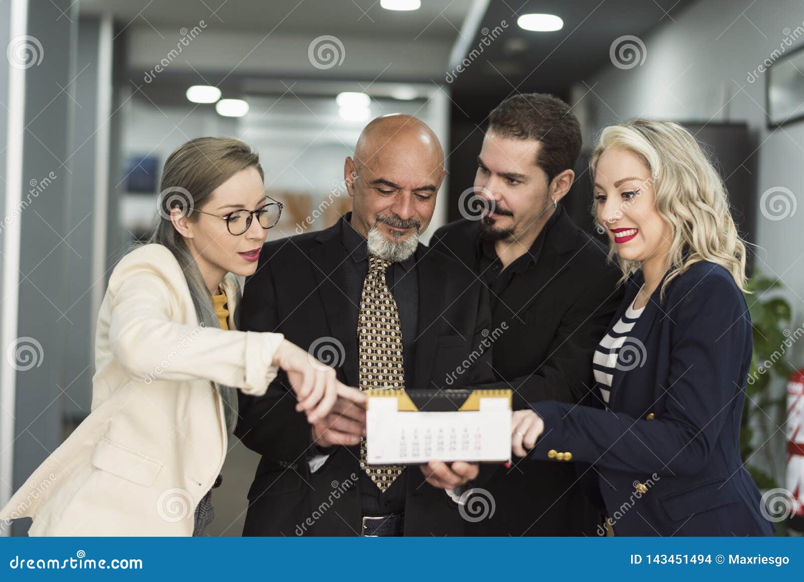 Group of Workers at Office with Calendar Choosing, Vacations or ...