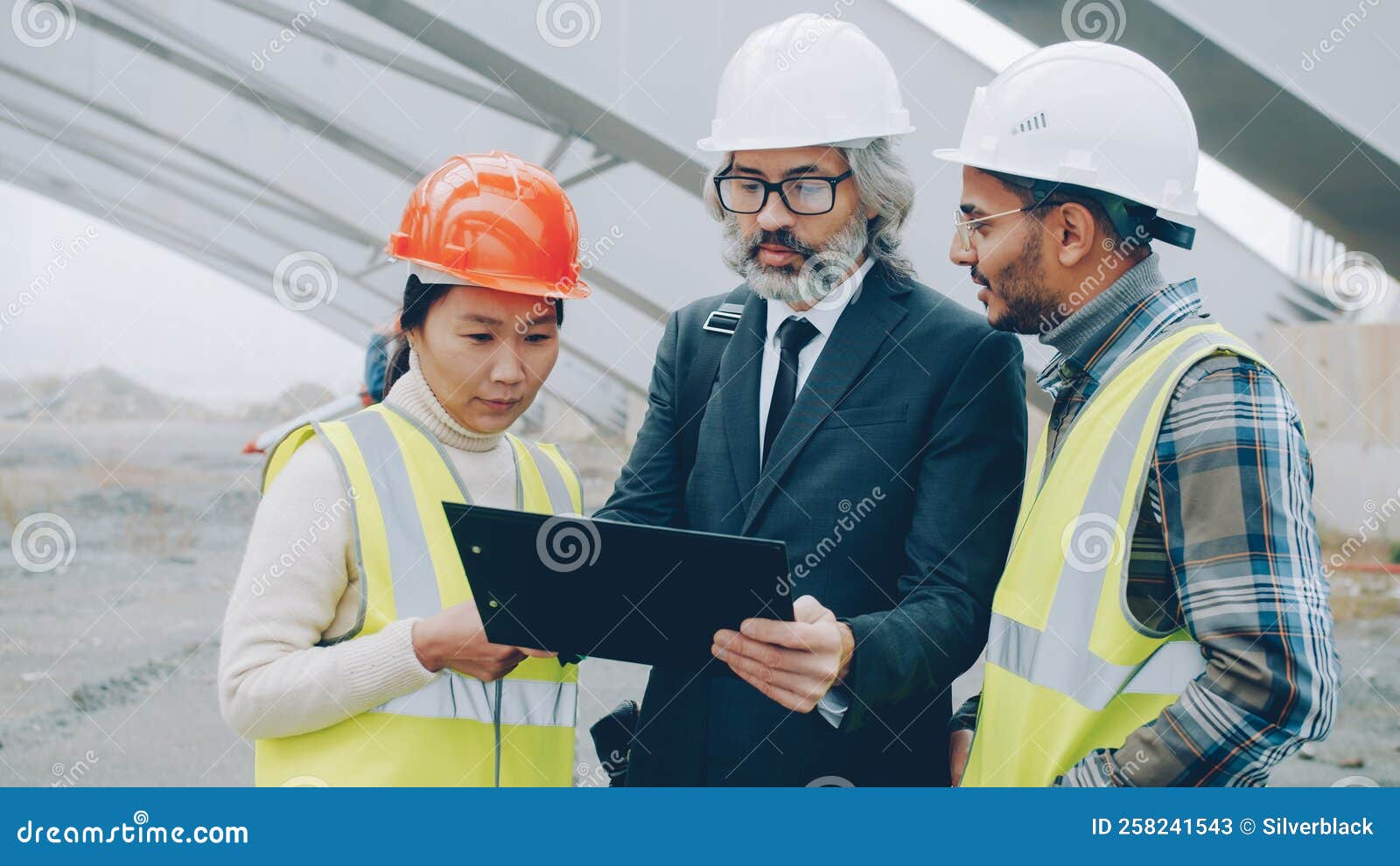 Group of Workers Talking To Construction Inspector Looking at ...
