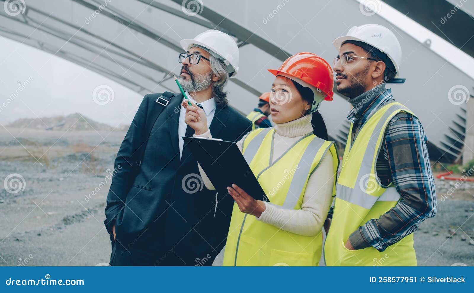 Group of Workers Talking To Construction Inspector Looking at ...