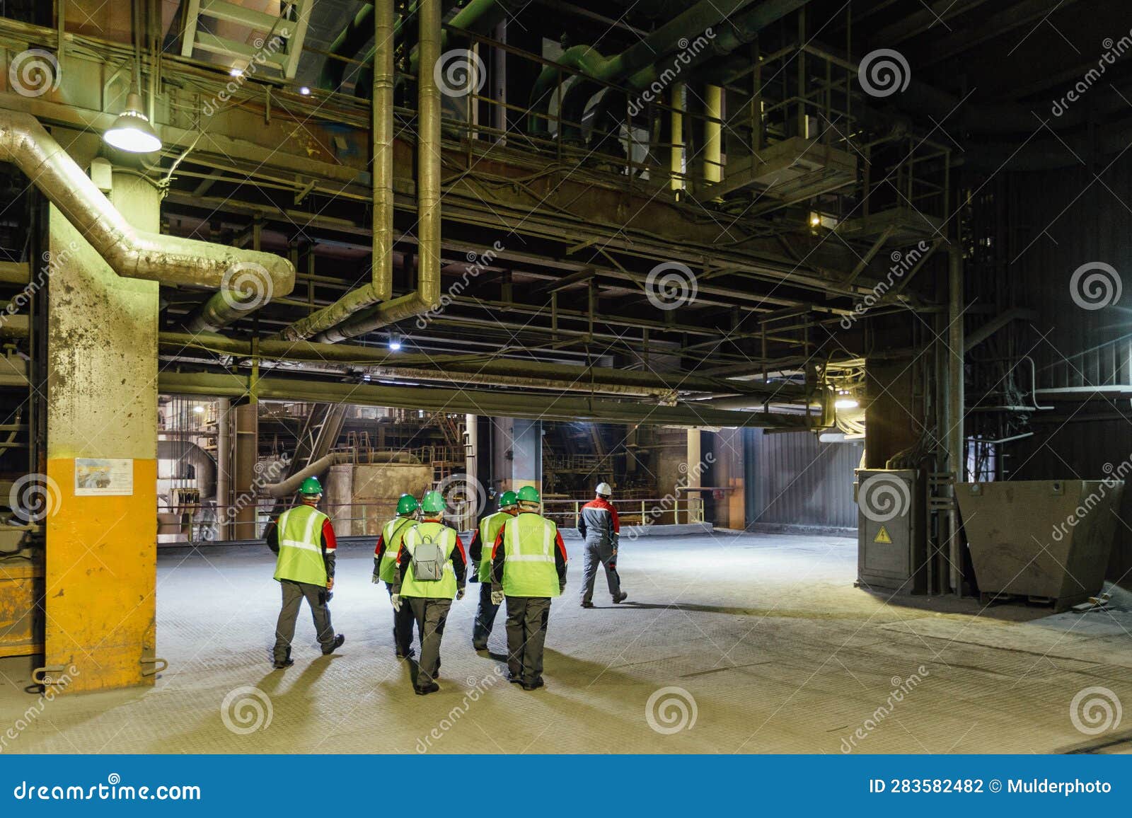 Group of Workers in Uniform Walking Along the Corridor of Factory Stock ...