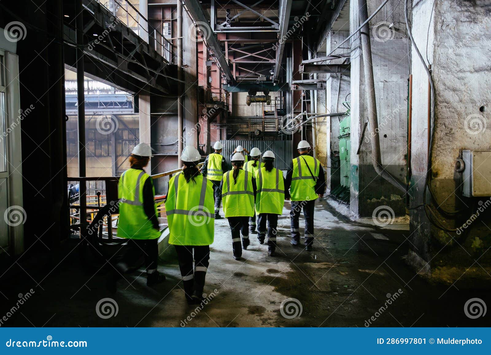 Group of Workers in Uniform Walking Along the Corridor of Factory Stock ...