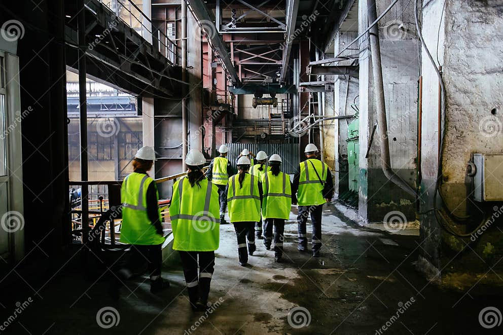 Group of Workers in Uniform Walking Along the Corridor of Factory Stock ...