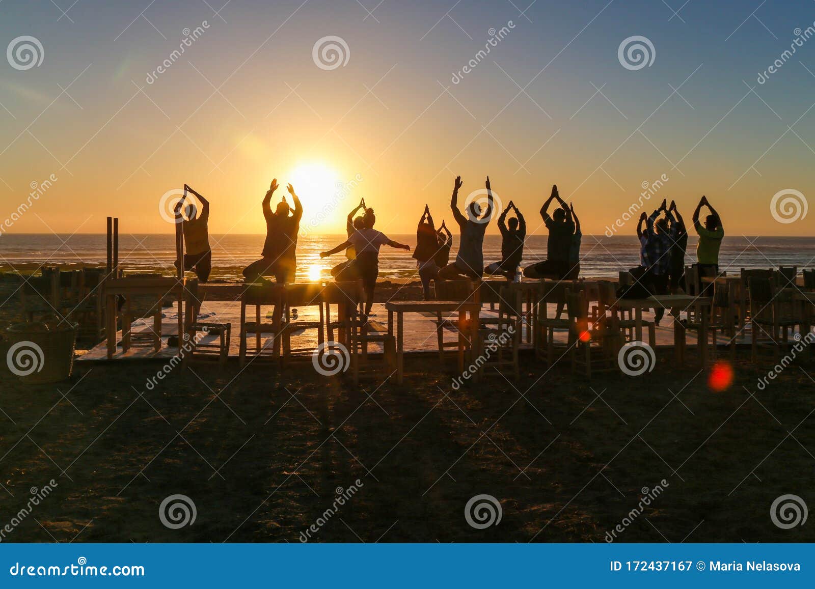 Group Doing Yoga Exercises on the Beach at Sunset Editorial Photography ...