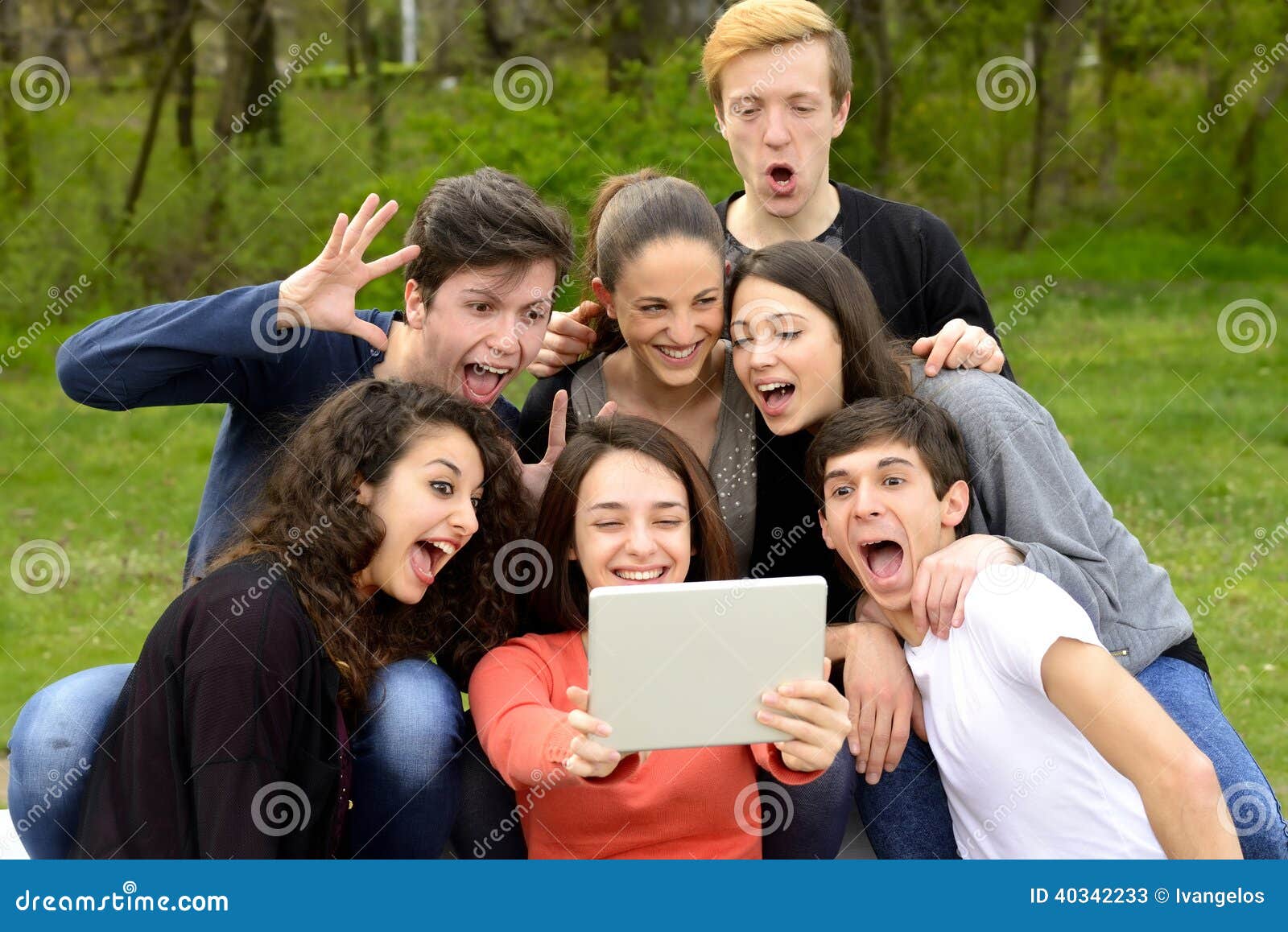 Group of Young Adults Browsing a Tablet Stock Image - Image of holidays ...