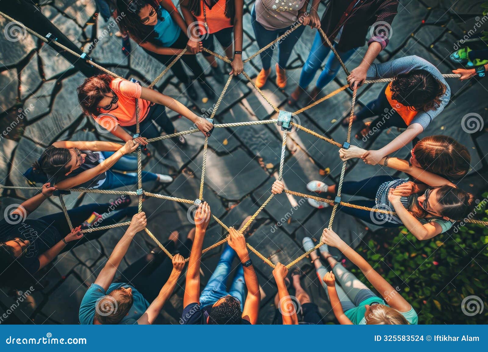 A Group of Young Adults Hold Onto Ropes, Forming a Circle in a Park ...