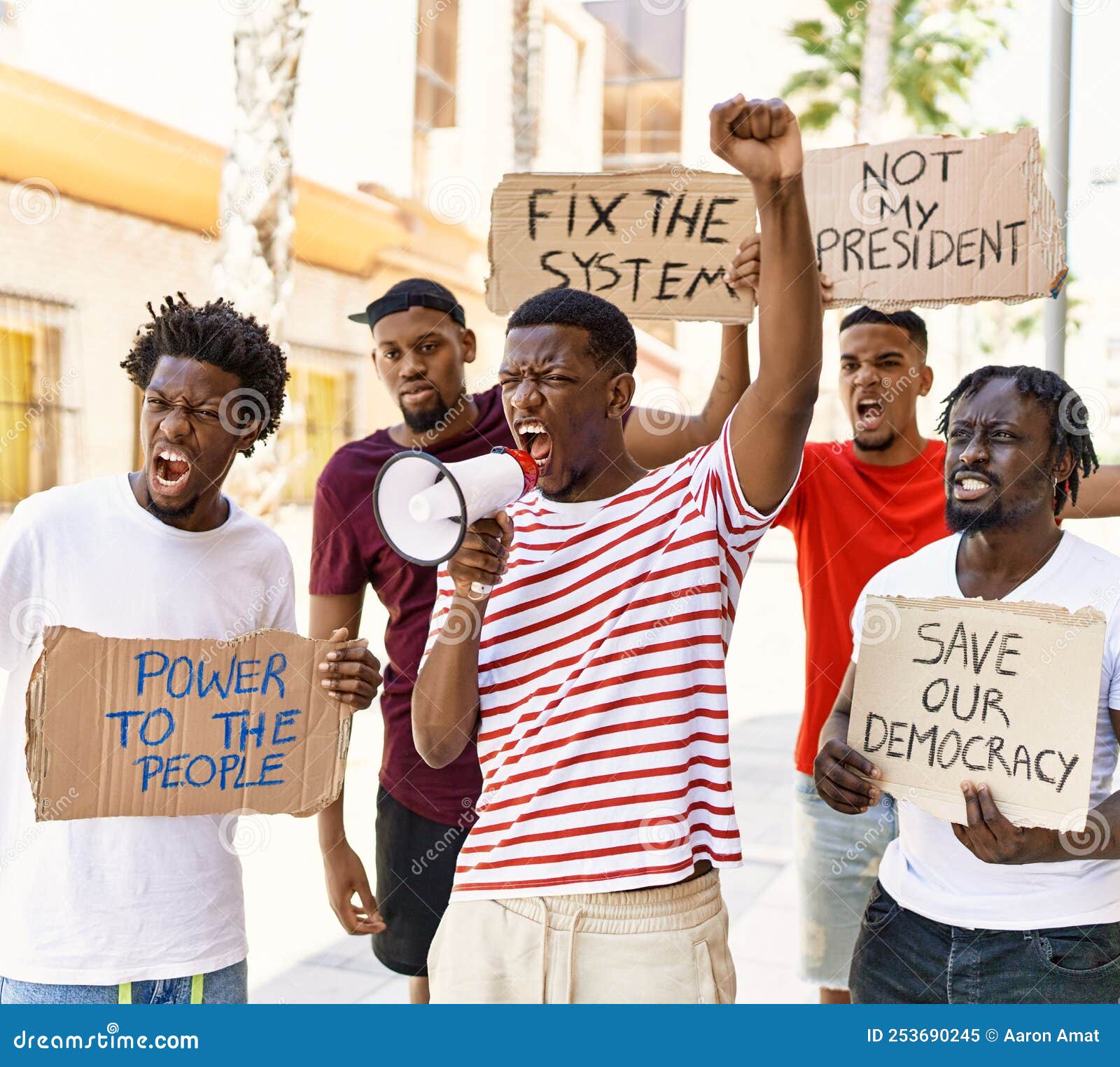 Group of Young African American Activists Protesting Holding Banner and ...