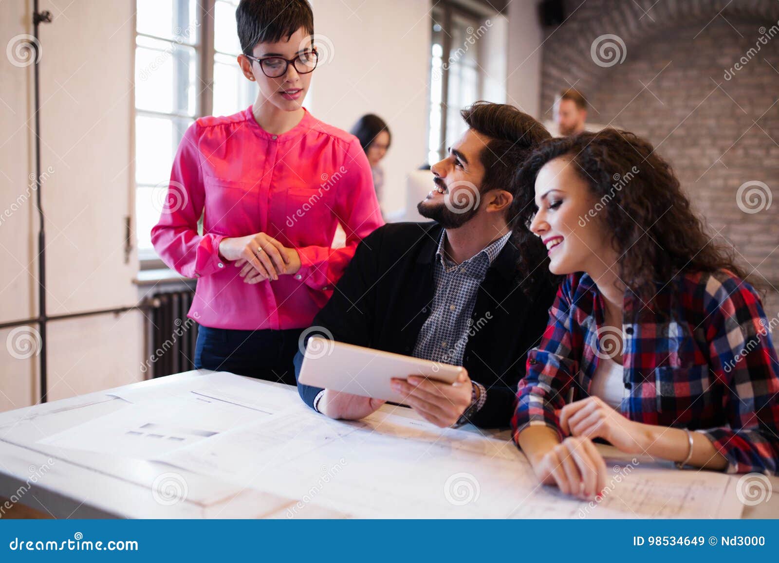 Group of Young Architects Looking at Digital Tablet Stock Image - Image ...