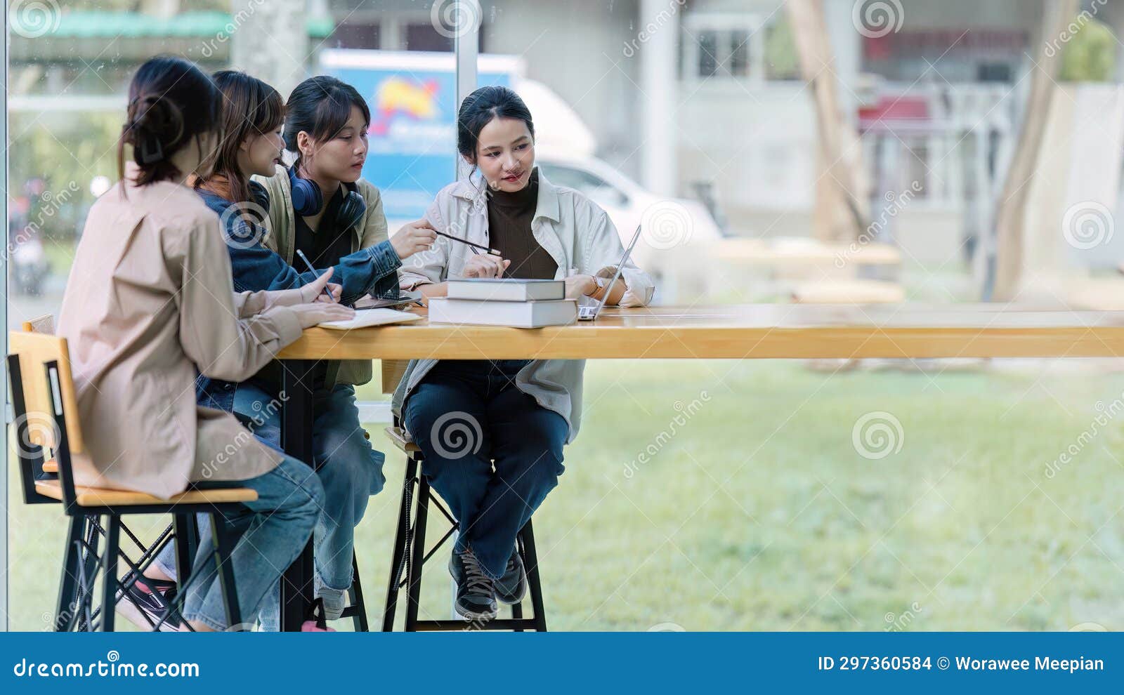 Group of Young Asian College Students Sitting on a Bench in a Campus ...