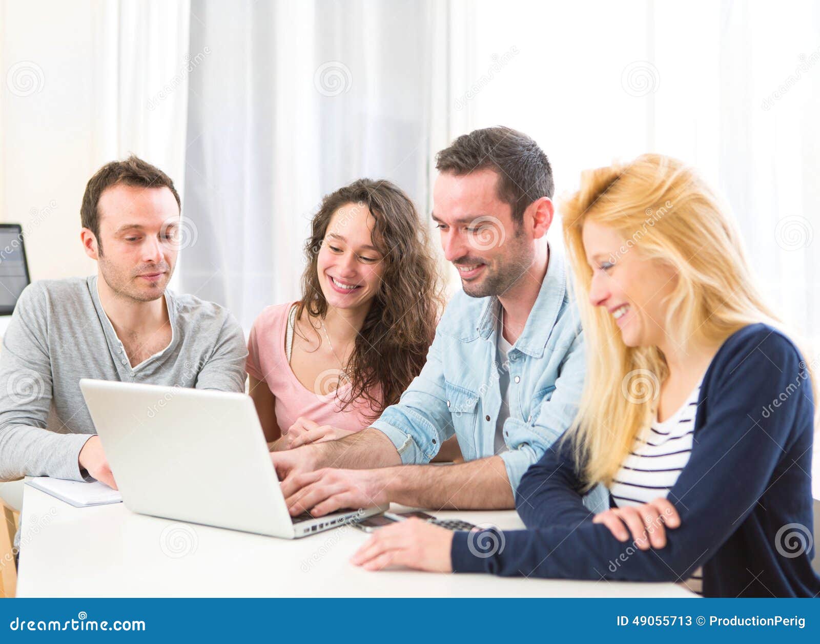 Group of 4 Young Attractive People Working on a Laptop Stock Image ...