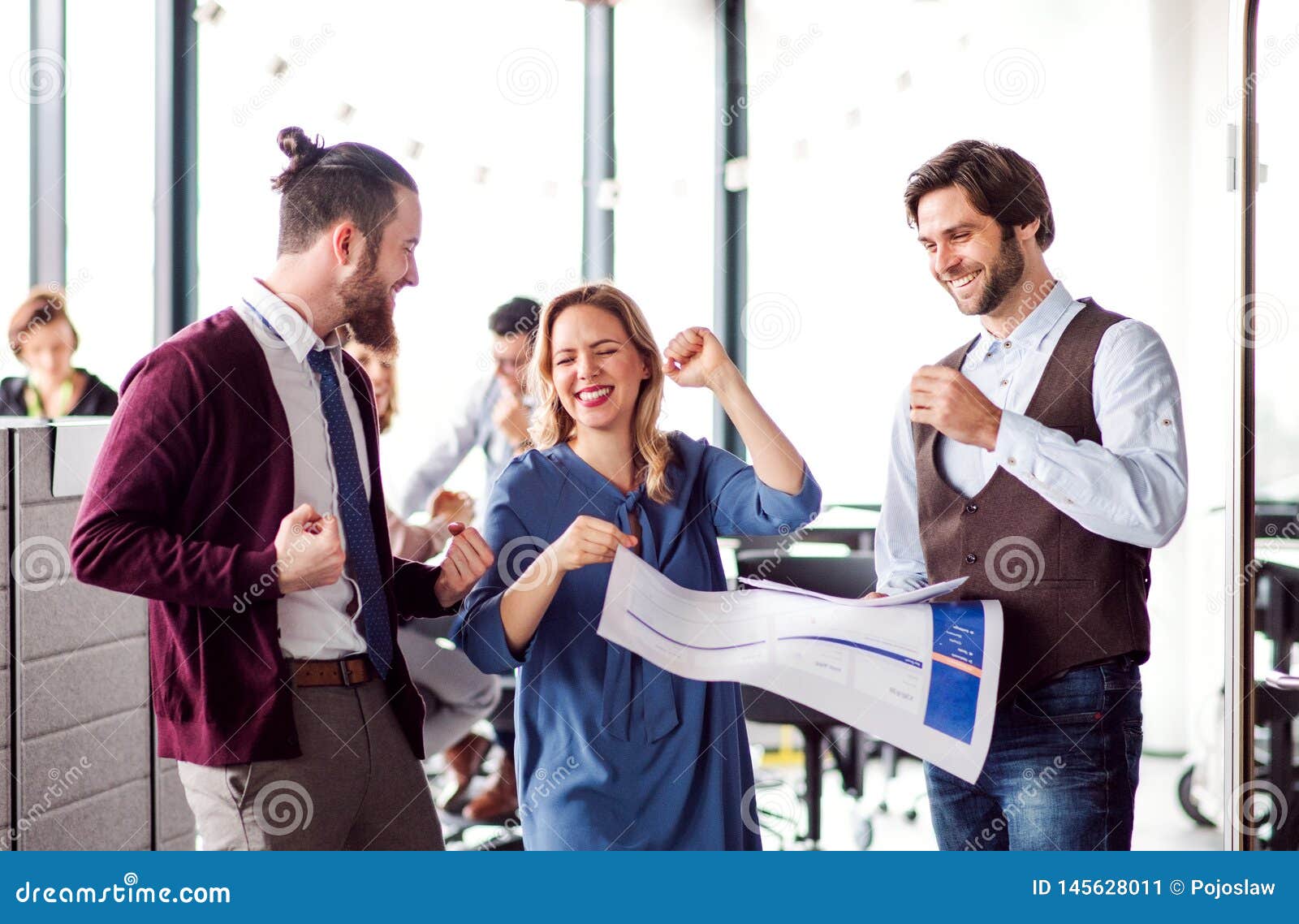 Group of Young Business People in an Office, Expressing Excitement ...