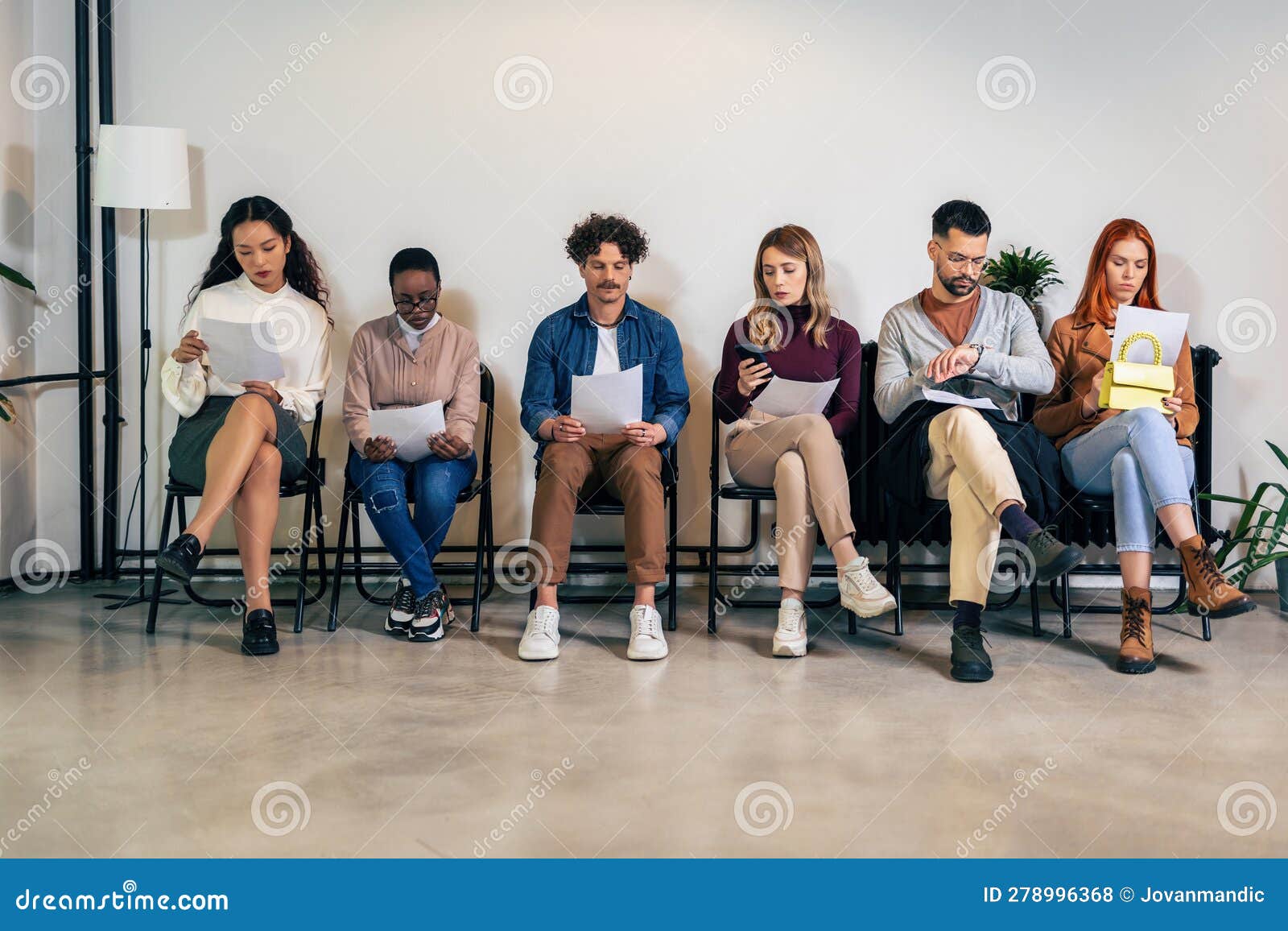 Young Business People Sitting in Chairs and Waiting for an Interview ...