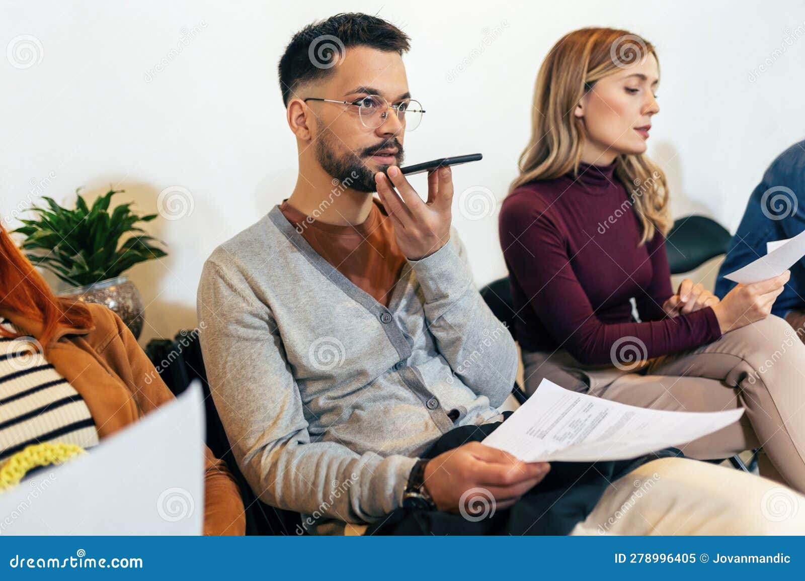 Young Business People Sitting in Chairs and Waiting for an Interview ...