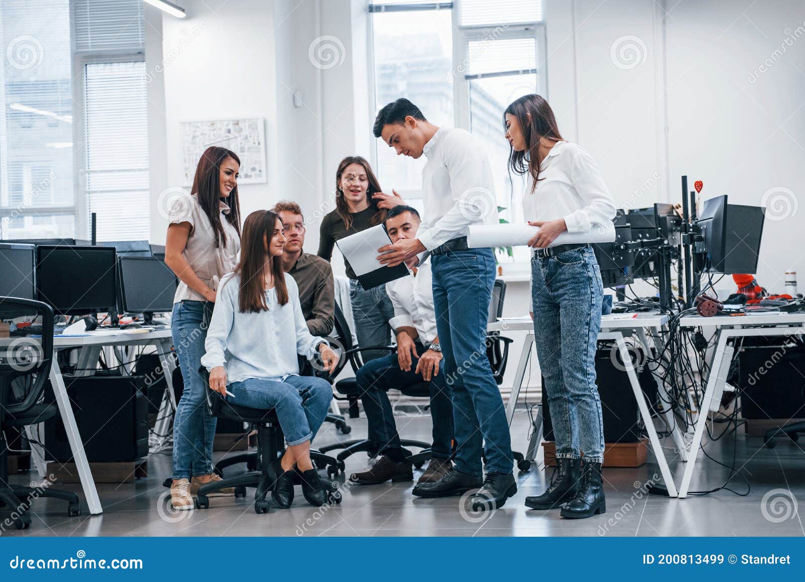 Group of Young Business People that Standing and Sitting and Working in ...