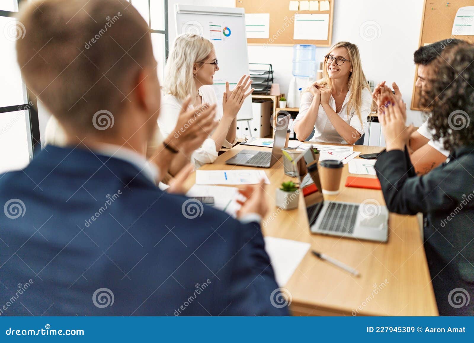 Group of Young Business Workers Smiling and Clapping To Partner at the ...