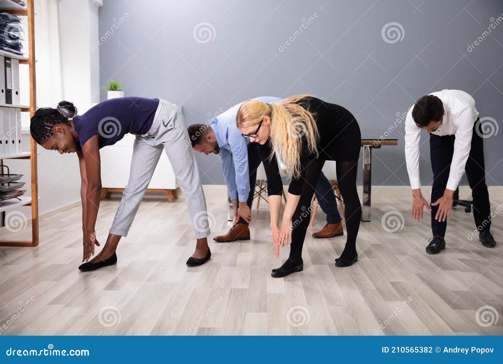 Businesspeople Doing Stretching Exercise in Office Stock Photo - Image ...