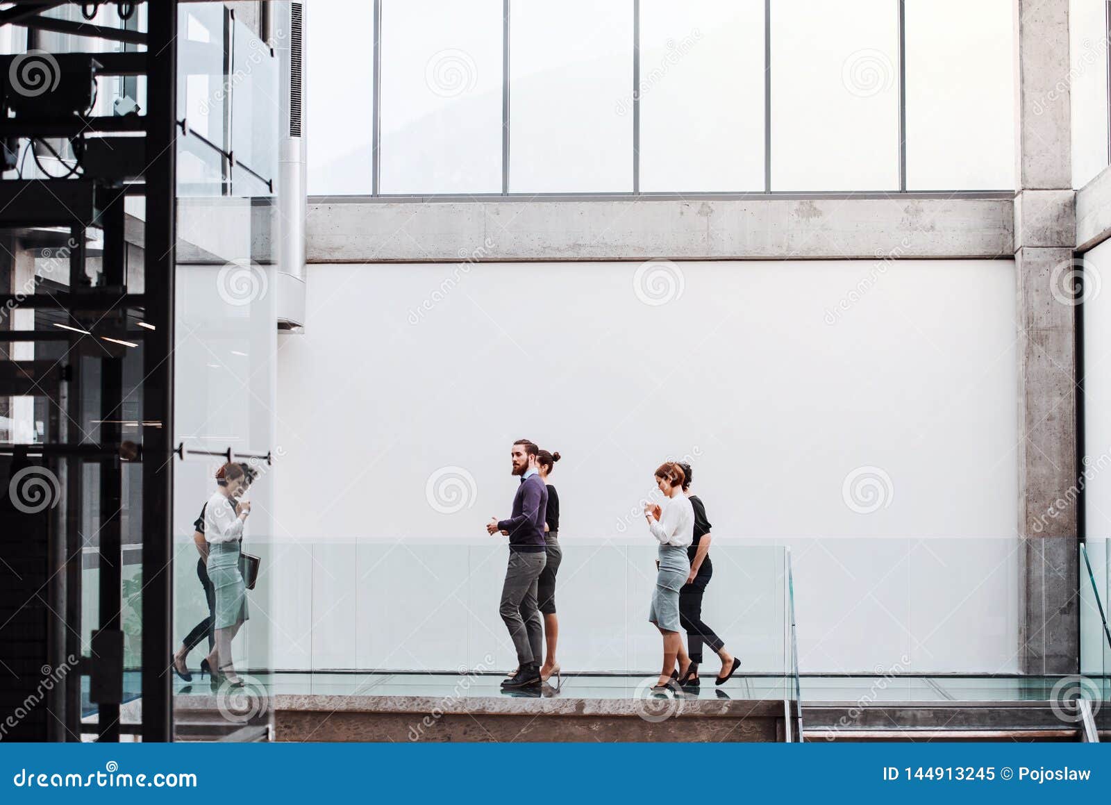 Group of Young Businesspeople at Work, Walking in the Building. Stock ...