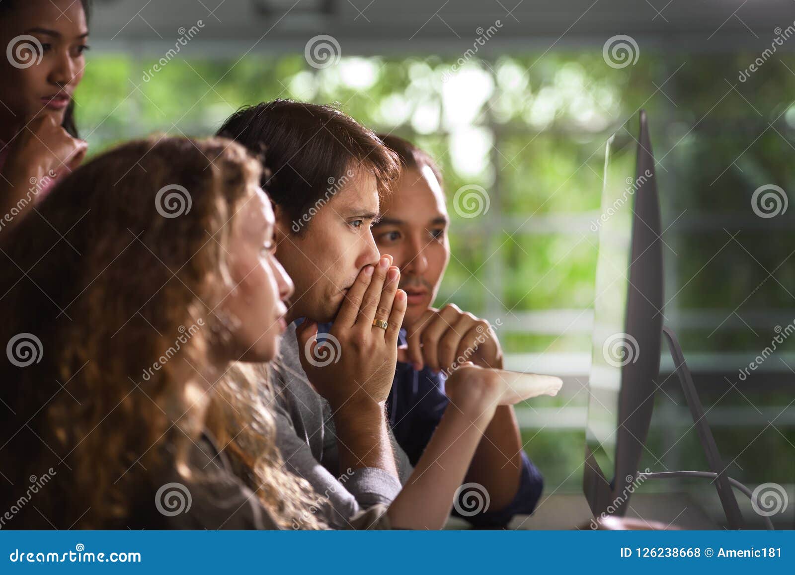 Group of Young Businesspersons Looking Intently at the Screen Stock ...