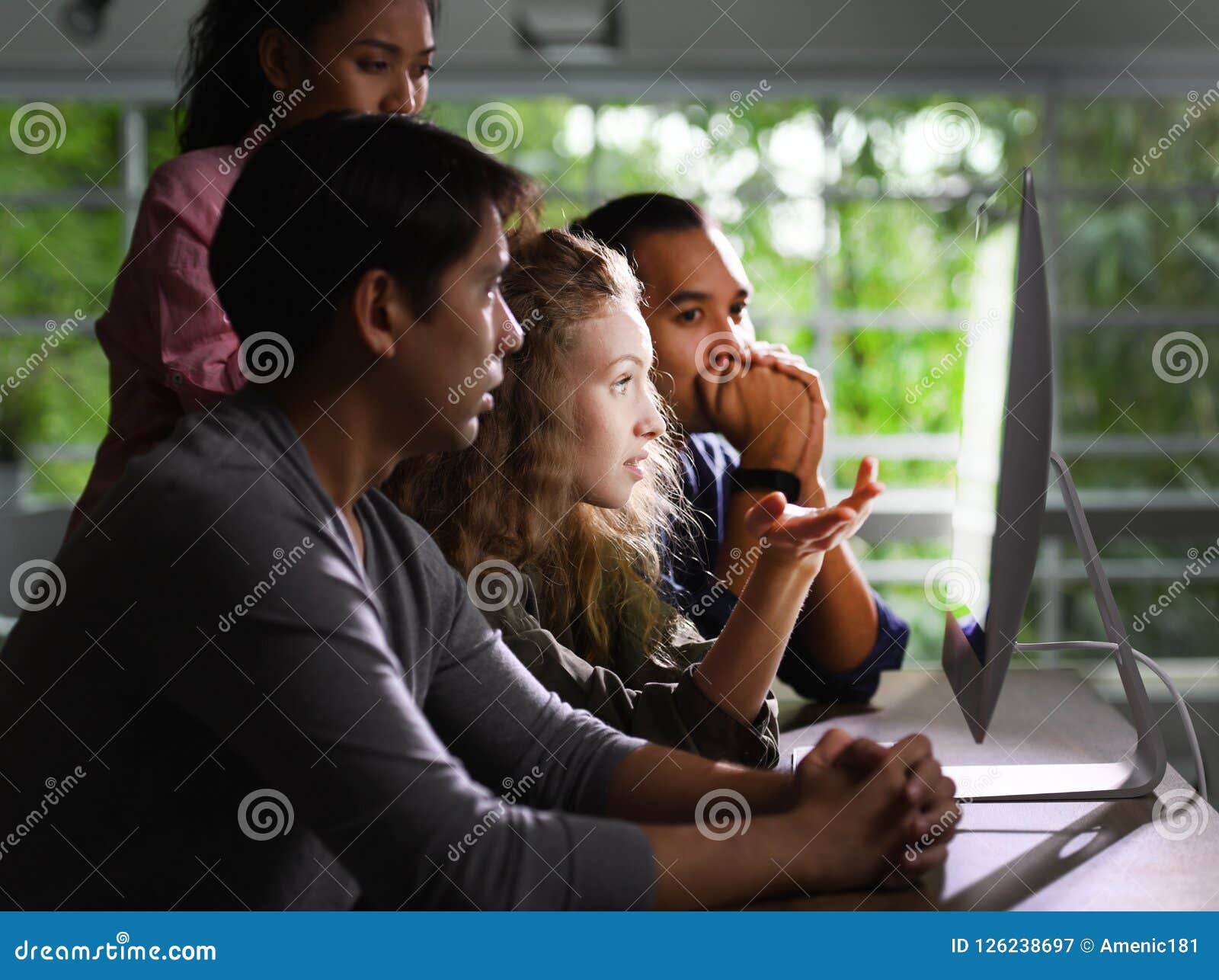 Group of Young Businesspersons Looking Intently at the Screen Stock ...
