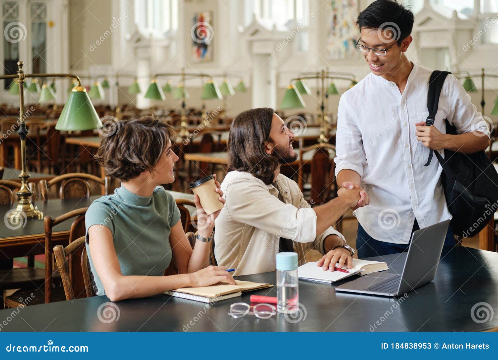 Group of Young Casual Students Happily Greeting Each Other while ...