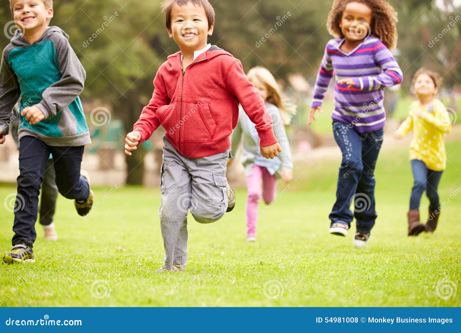 Group of Young Children Running Towards Camera in Park Stock Photo ...