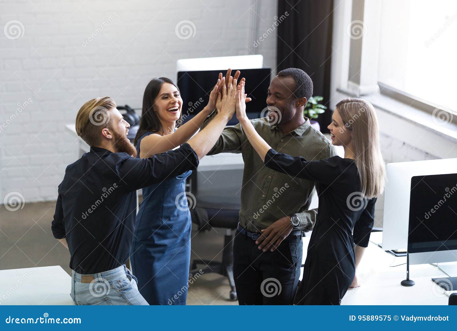 Group of Young Colleagues Giving Each Other a High Five Stock Image ...