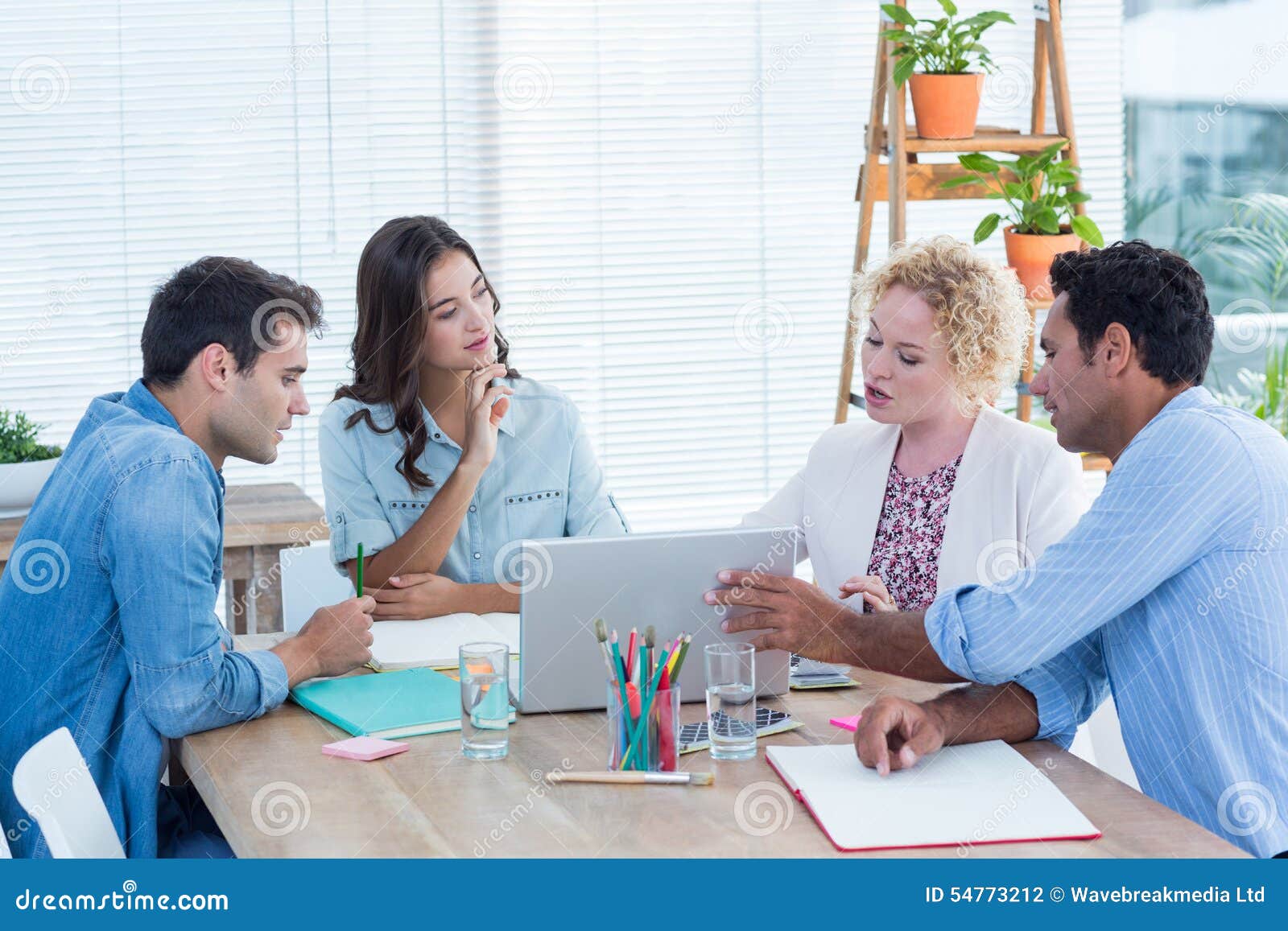 Group of Young Colleagues Using Laptop in a Meeting Stock Photo - Image ...