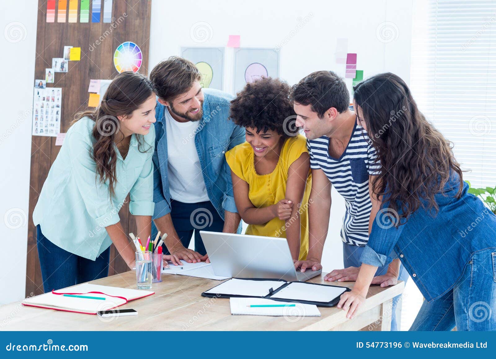 Group of Young Colleagues Using Laptop Stock Photo - Image of brown ...