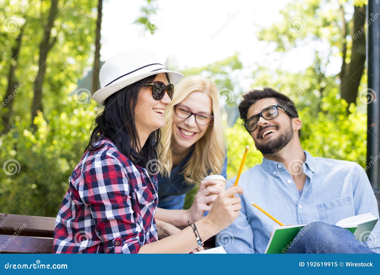 Group of Young College Students Having Fun while Discussing Homework on ...