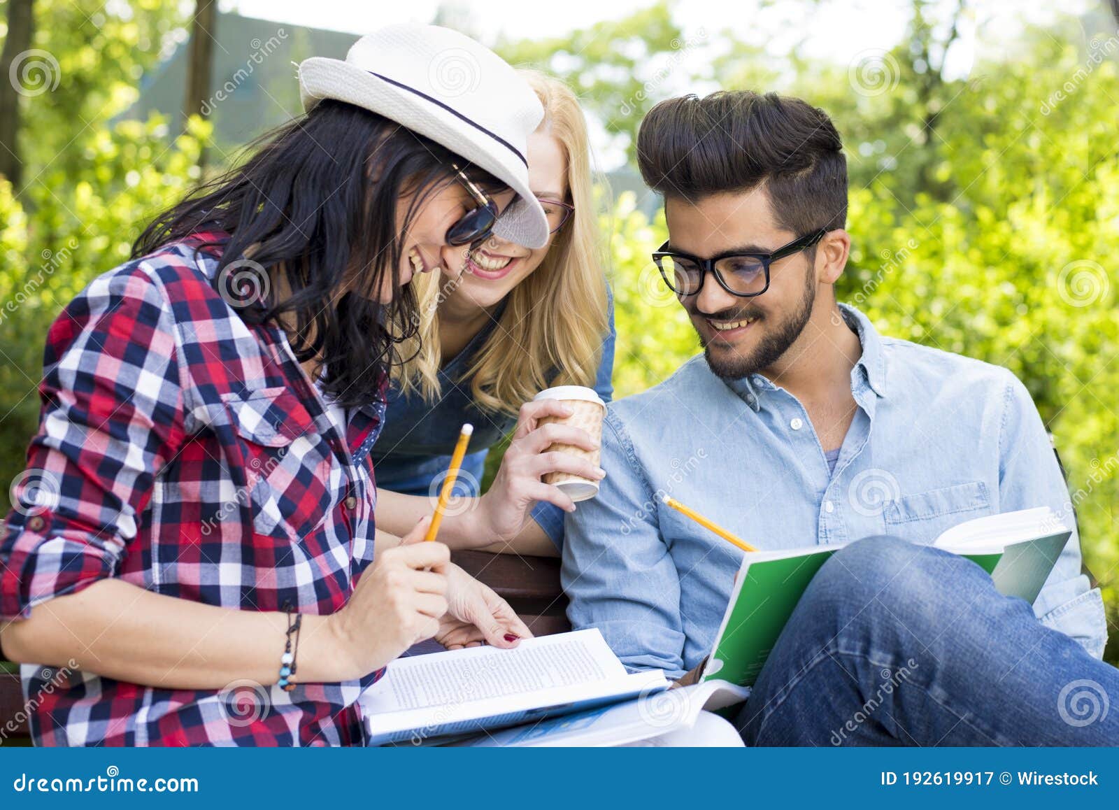 Group of Young College Students Having Fun while Discussing Homework on ...
