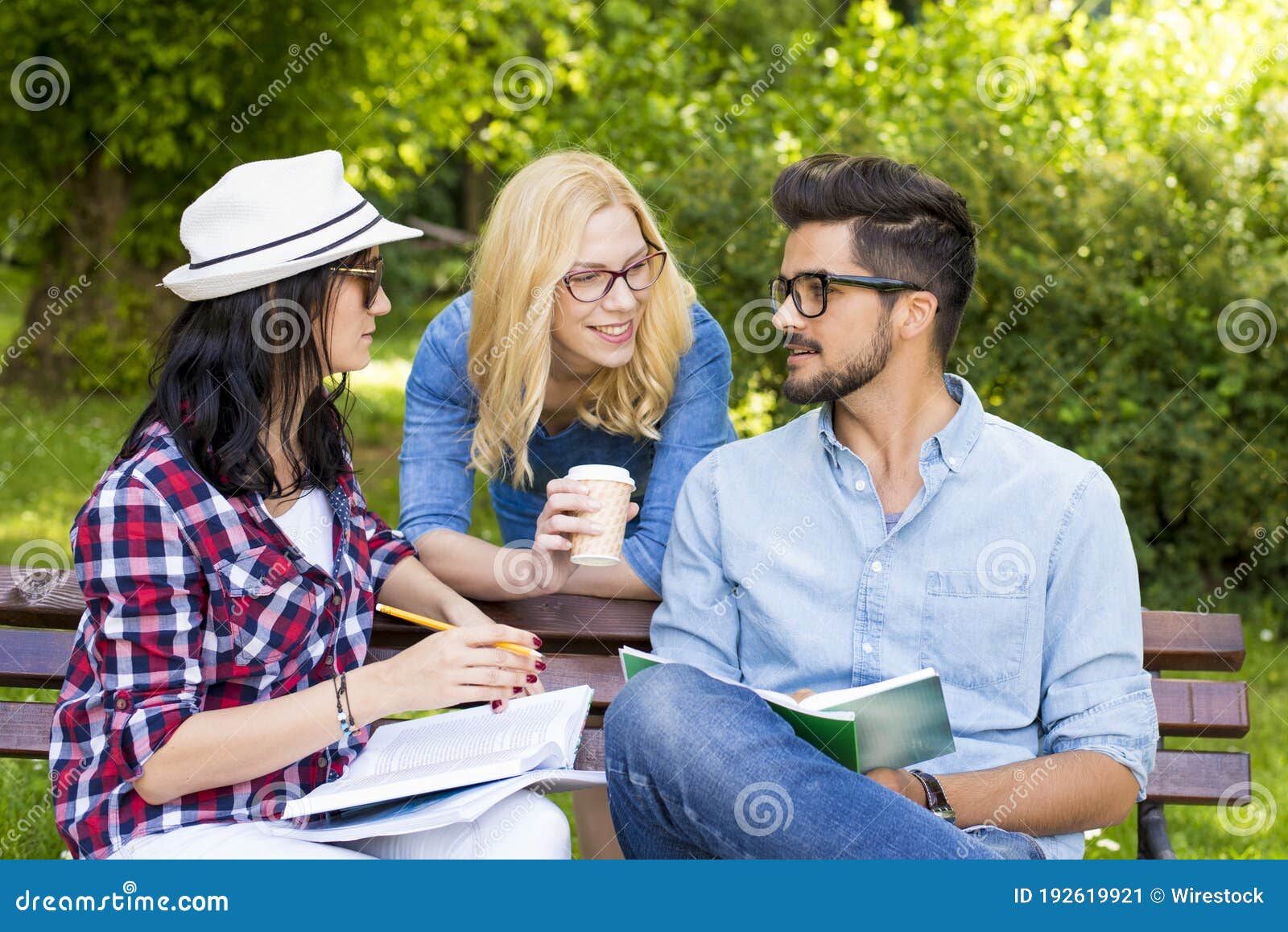 Group of Young College Students Having Fun while Discussing Homework on ...