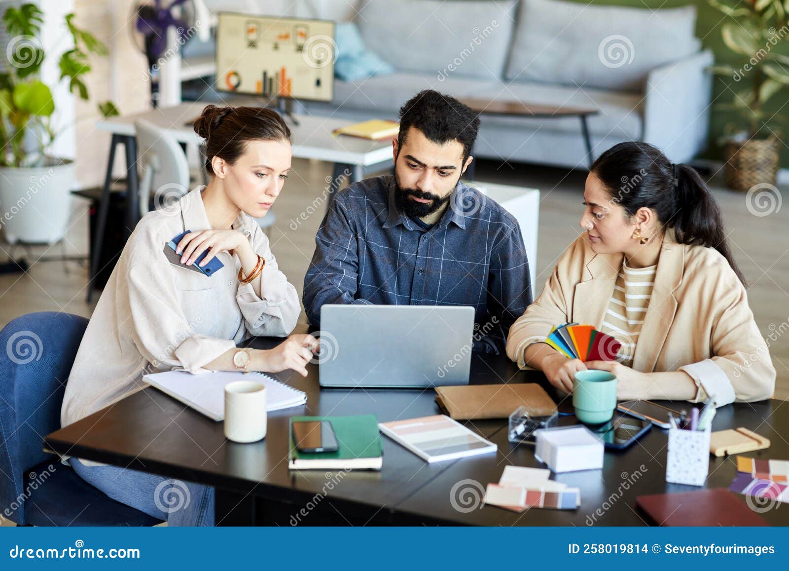 Group of Young Confident Coworkers Watching Online Video Presentation ...