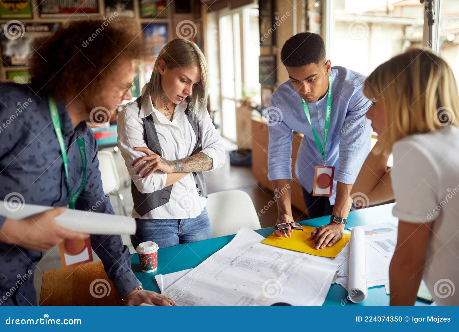 A Group of Young Creative Colleagues is Analyzing Some Project Drafts ...