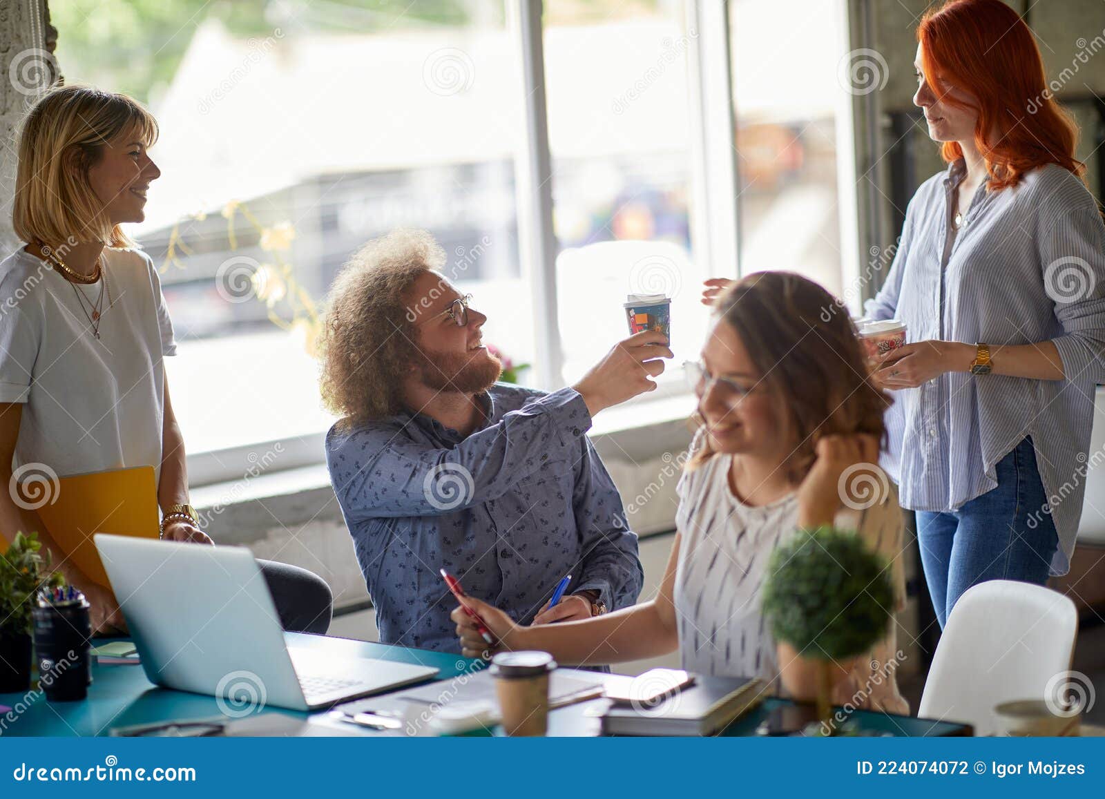 Group of Young Creative Colleagues Enjoying Coffee while Working in the ...