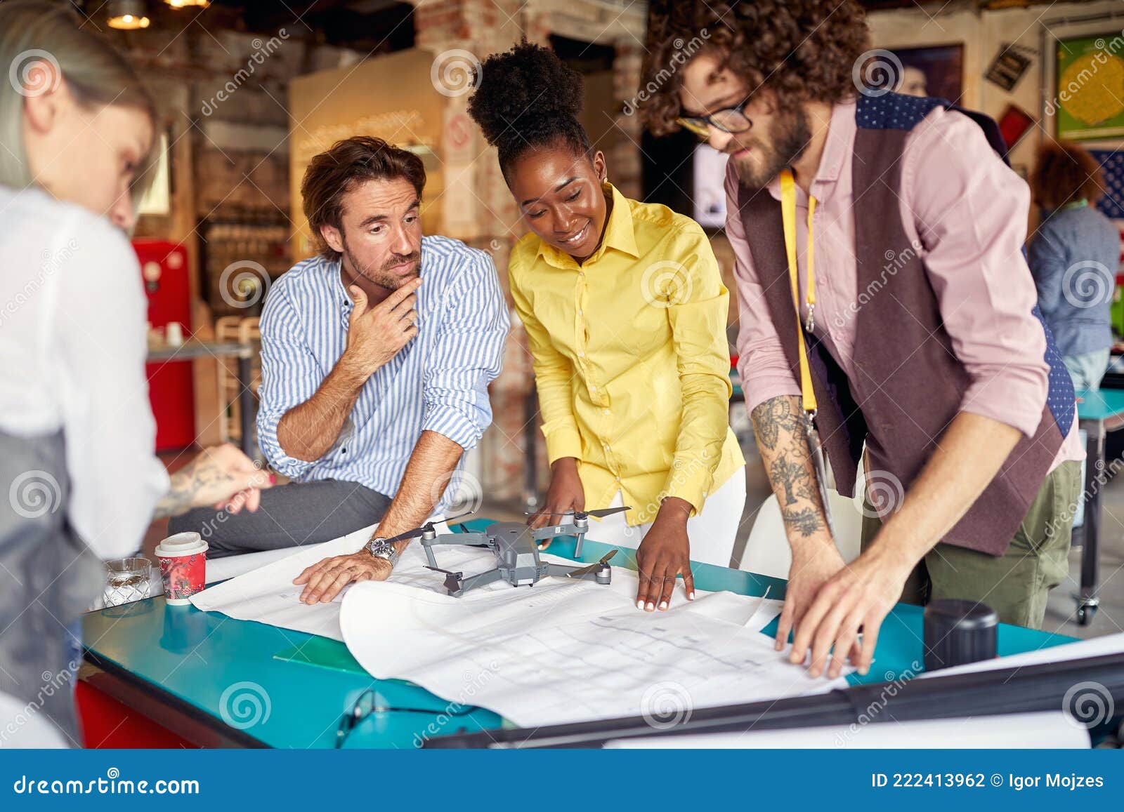 Group of Young Creative Employees is Reviewing Project Drafts in the ...