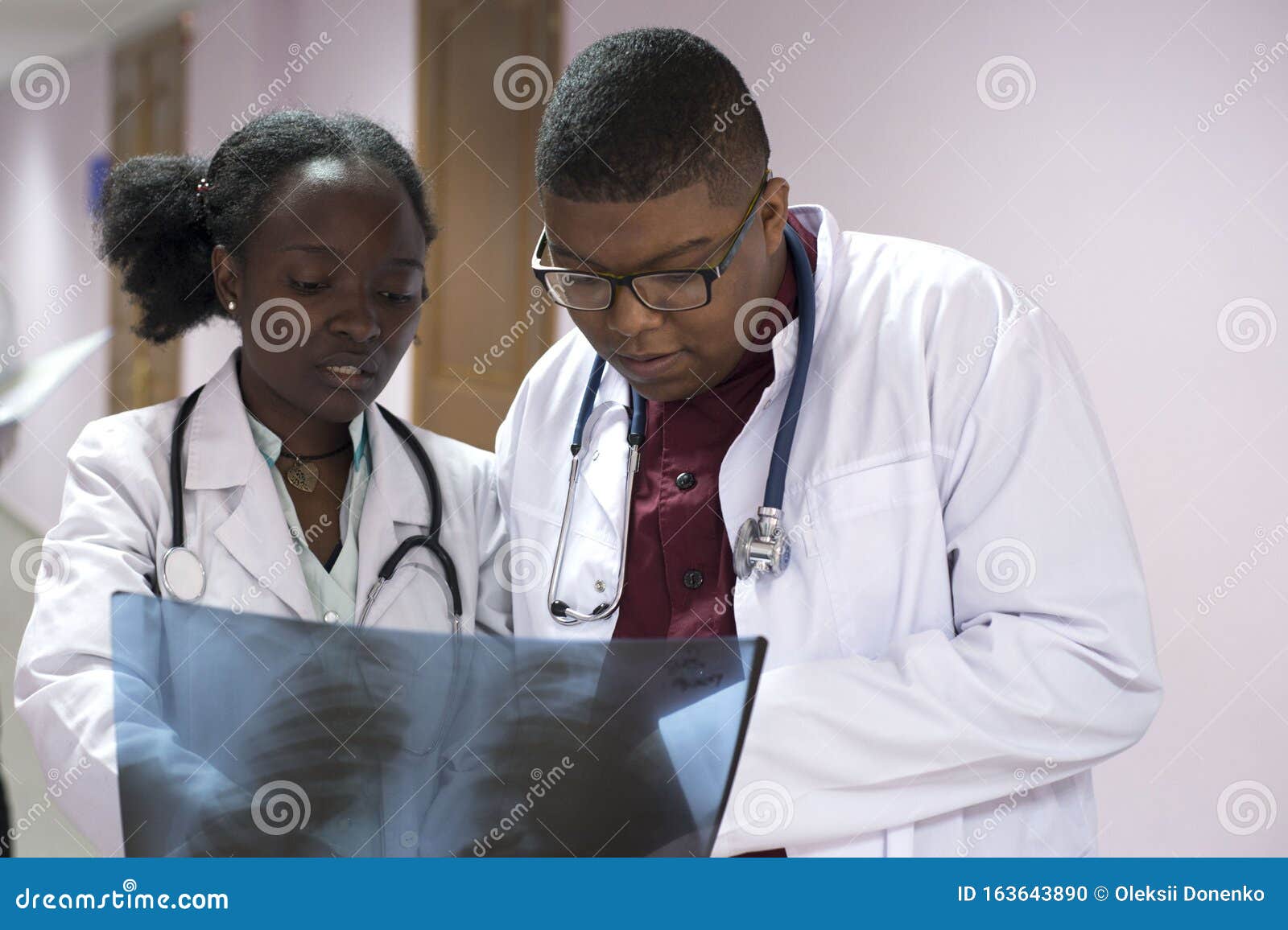 A Group of Young Doctors, Mixed Race. in the Corridor of the Hospital ...