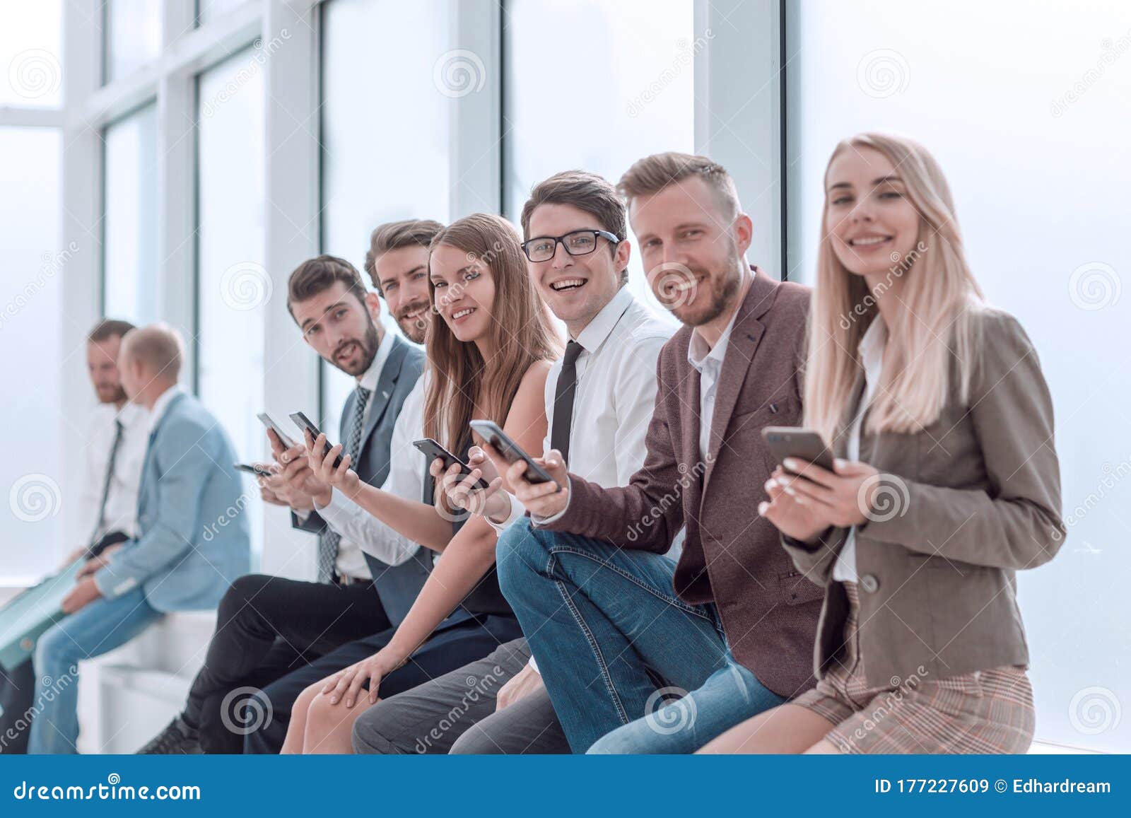 Group of Young Employees Sitting in the Office Corridor. Stock Image ...