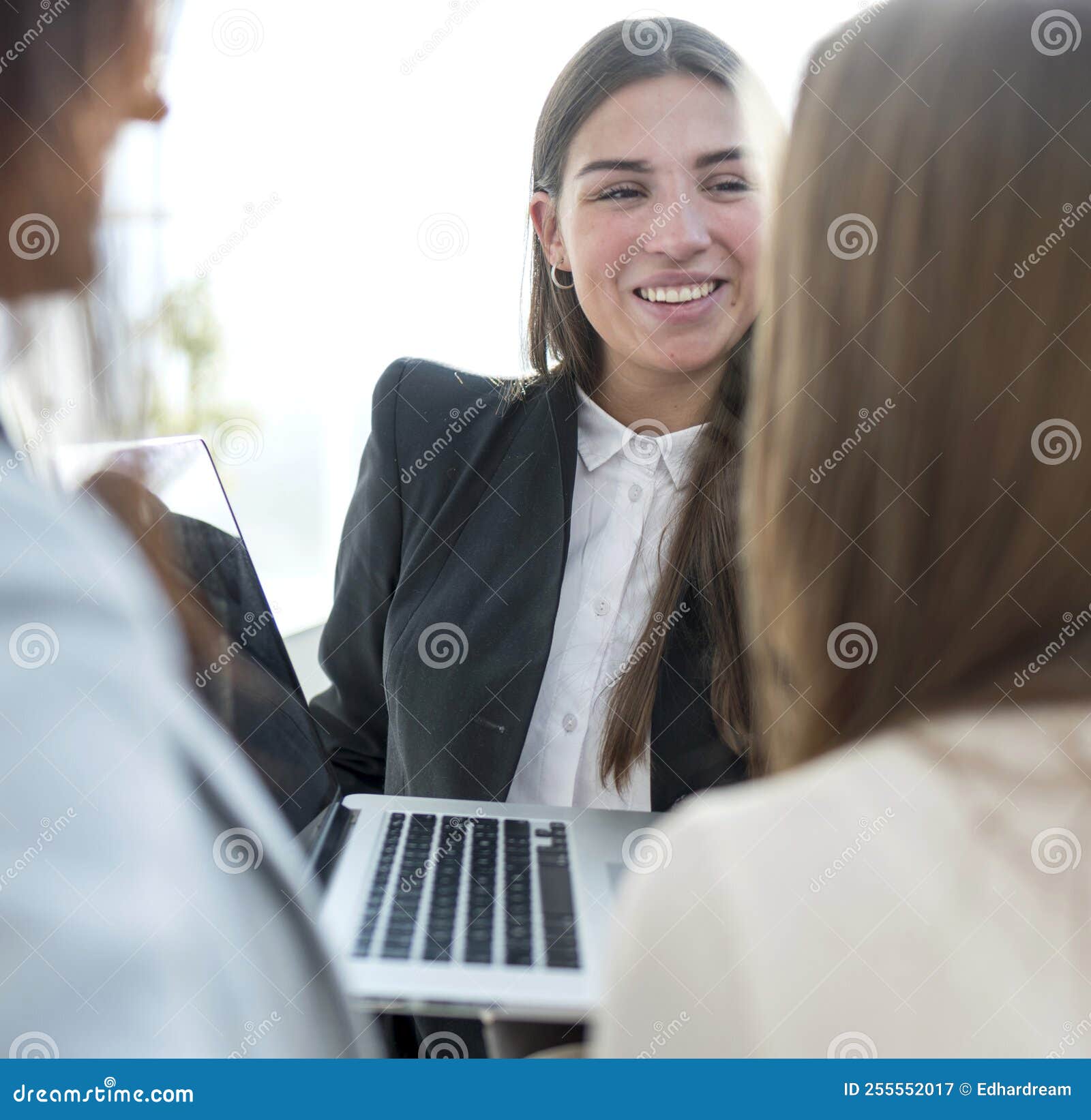 Group of Young Employees Standing Near an Open Laptop Stock Image ...
