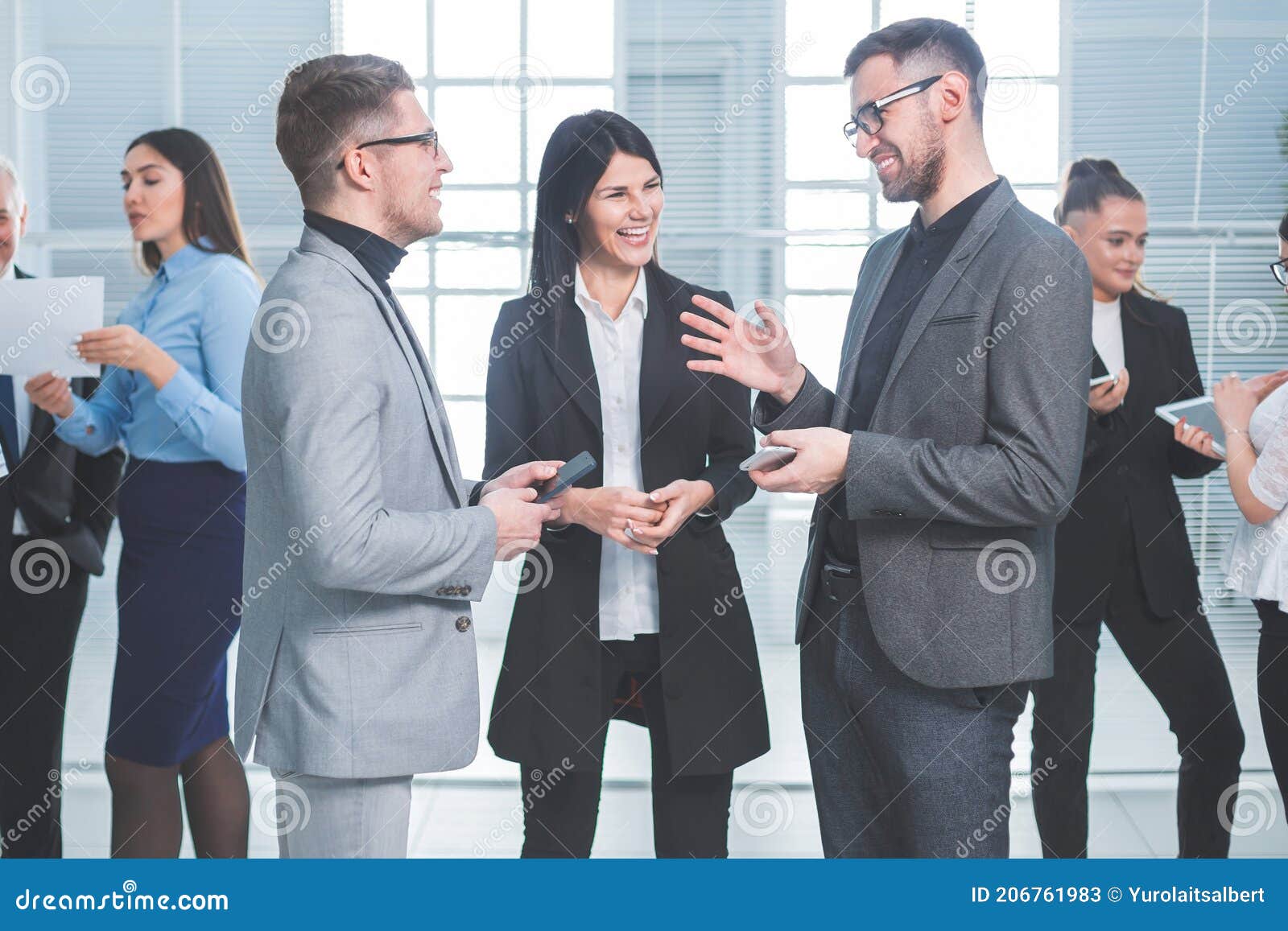 Group of Young Employees Standing in the Office Lobby during a Work ...